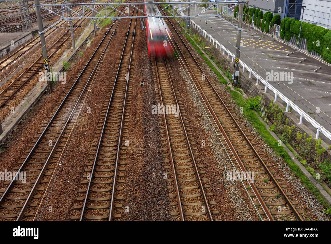 Rush hour commuter train speeds down center track on multiple train ...