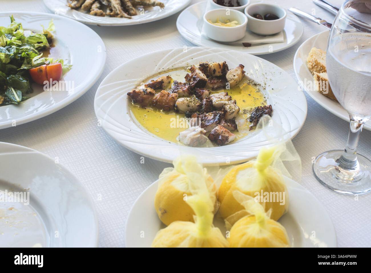 Octopus in a Greek restaurant. White table. Greece, Athens, Piraeus ...