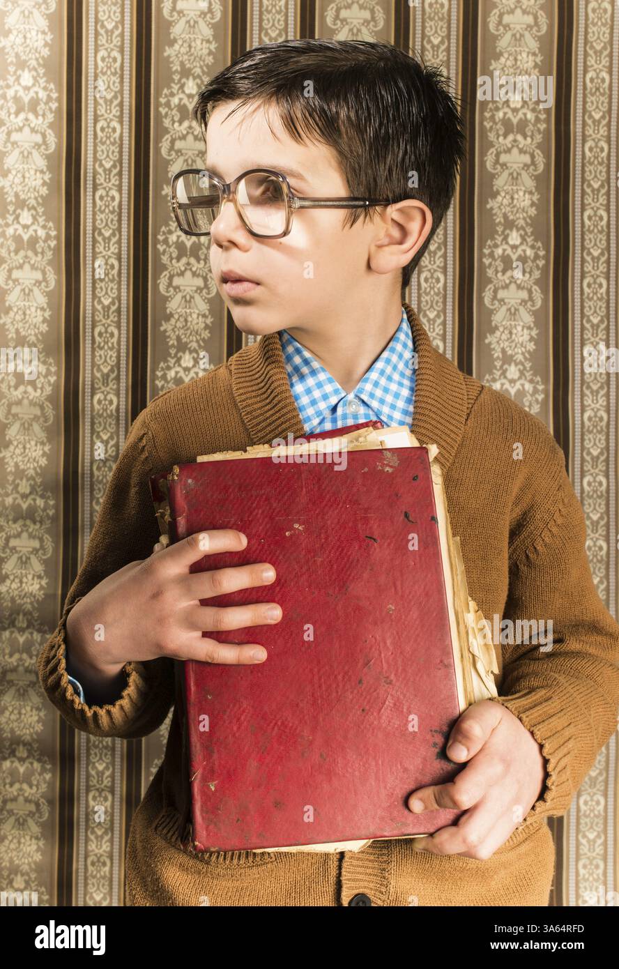 Child with glasses hold red vintage book. Vintage clothes Stock Photo ...