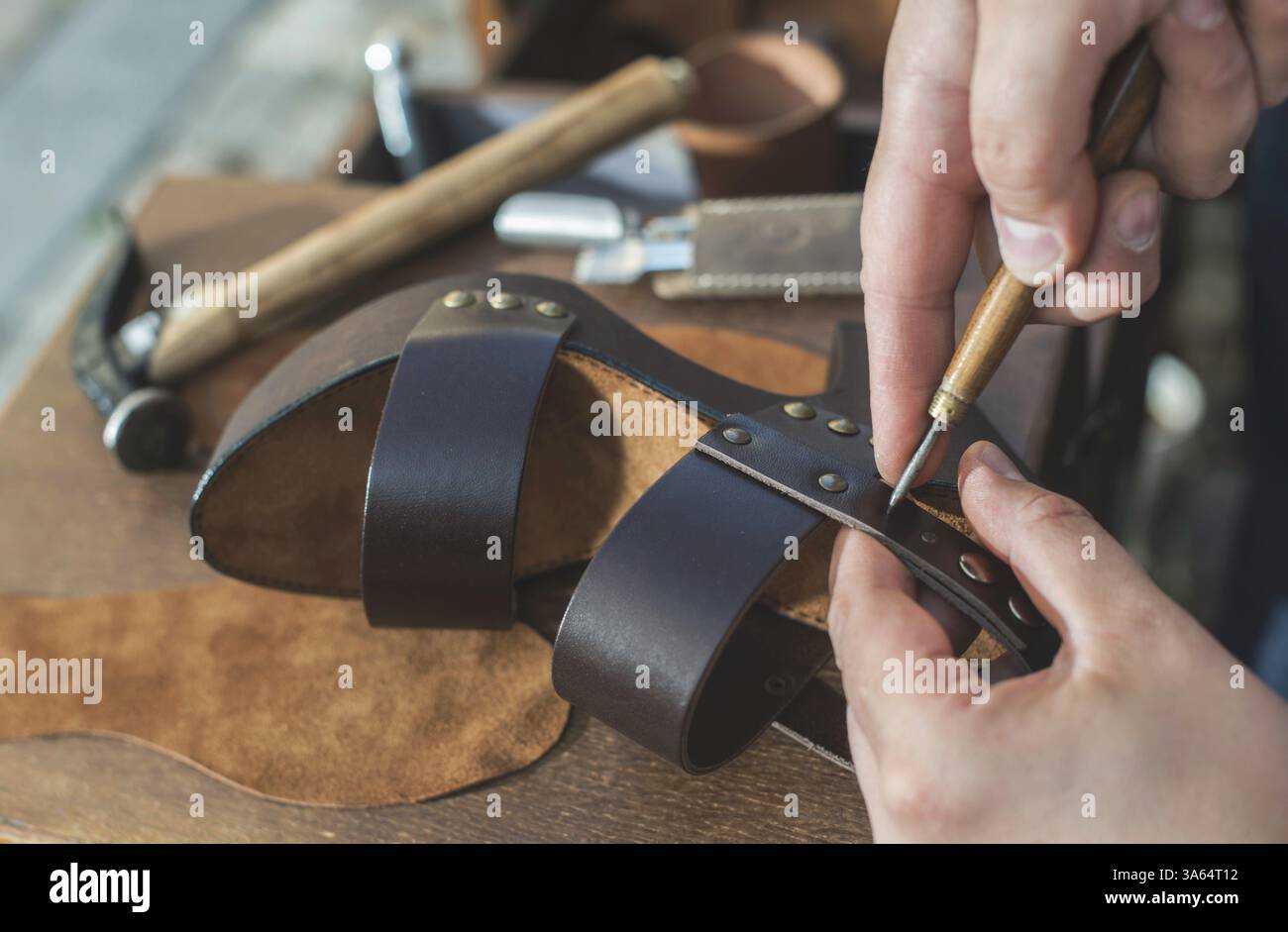 Making shoes manual. Leather sandals Stock Photo - Alamy