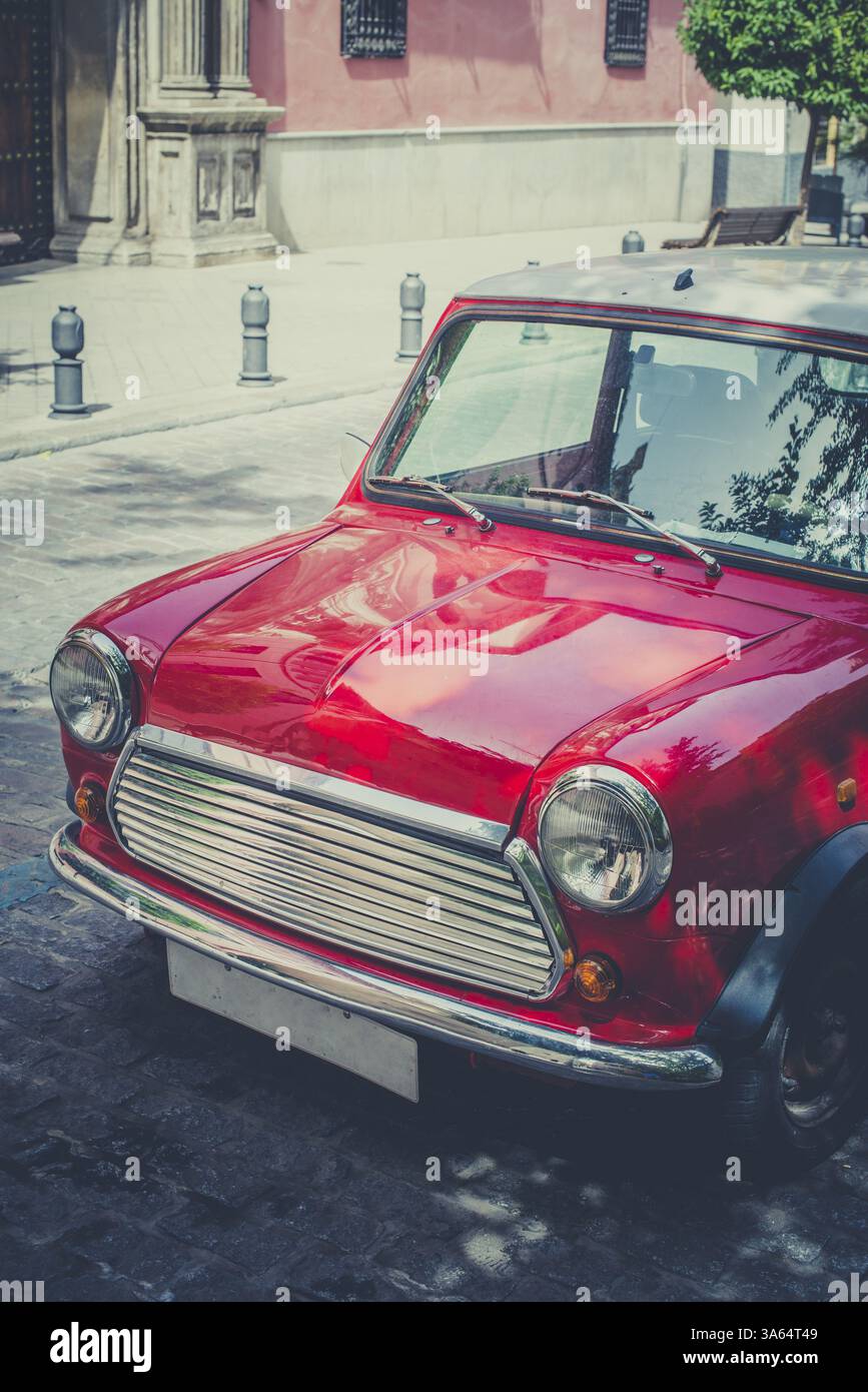 Vintage small red car on the street Stock Photo - Alamy