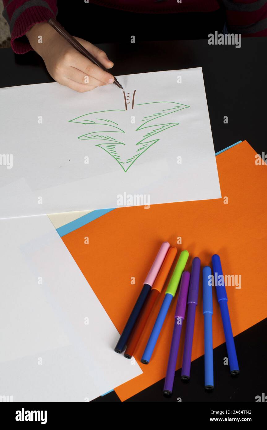 Boy drawing with markers. Multicolored papers Stock Photo - Alamy