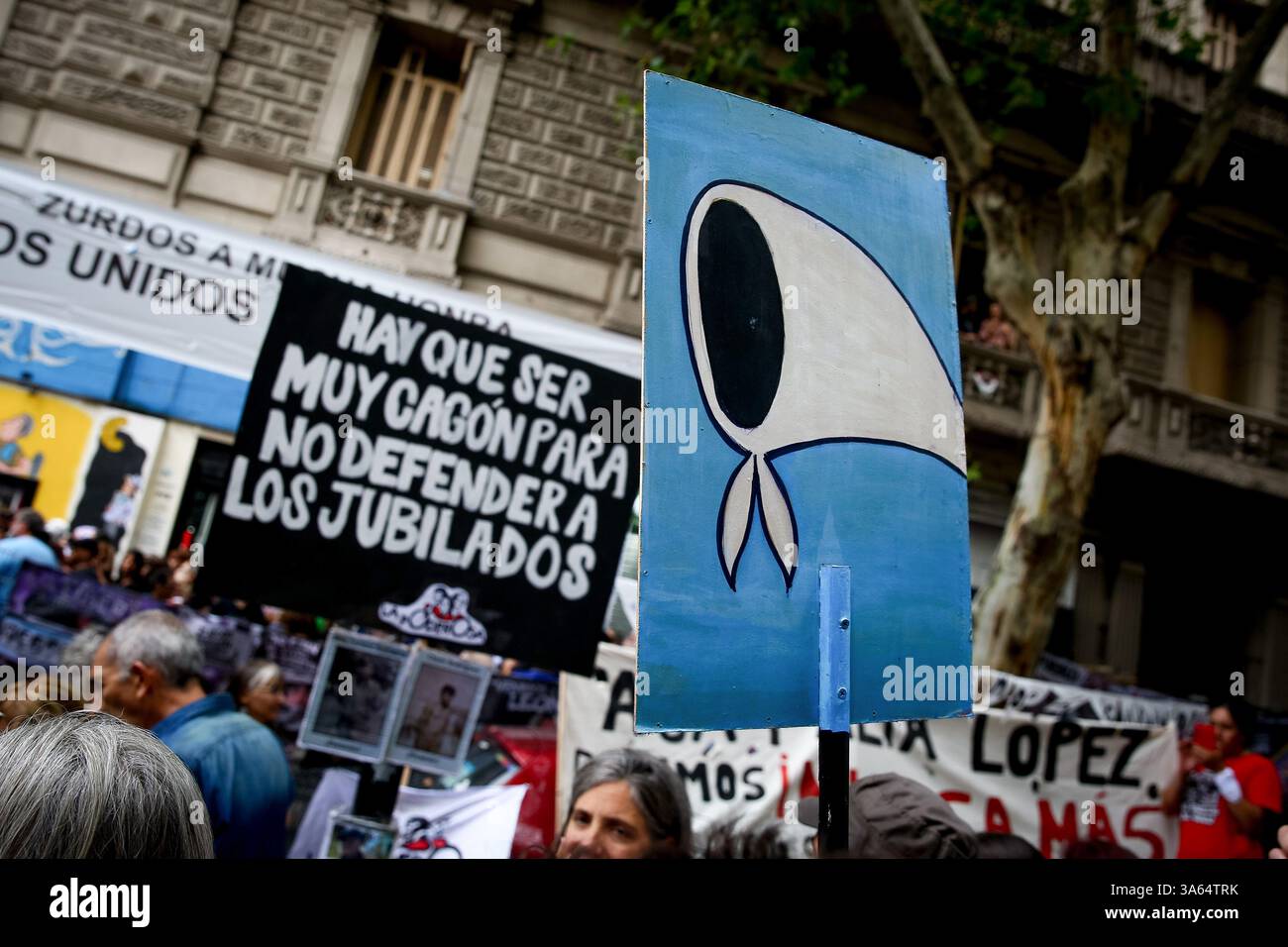 Protesters hold placards during the demonstration to commemorate the ...