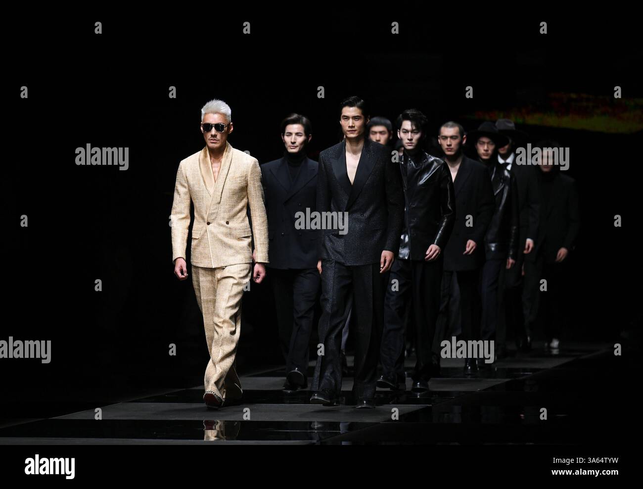 Chinese model Hu Bing (left) presents a creation from Fire 2025 autumn ...