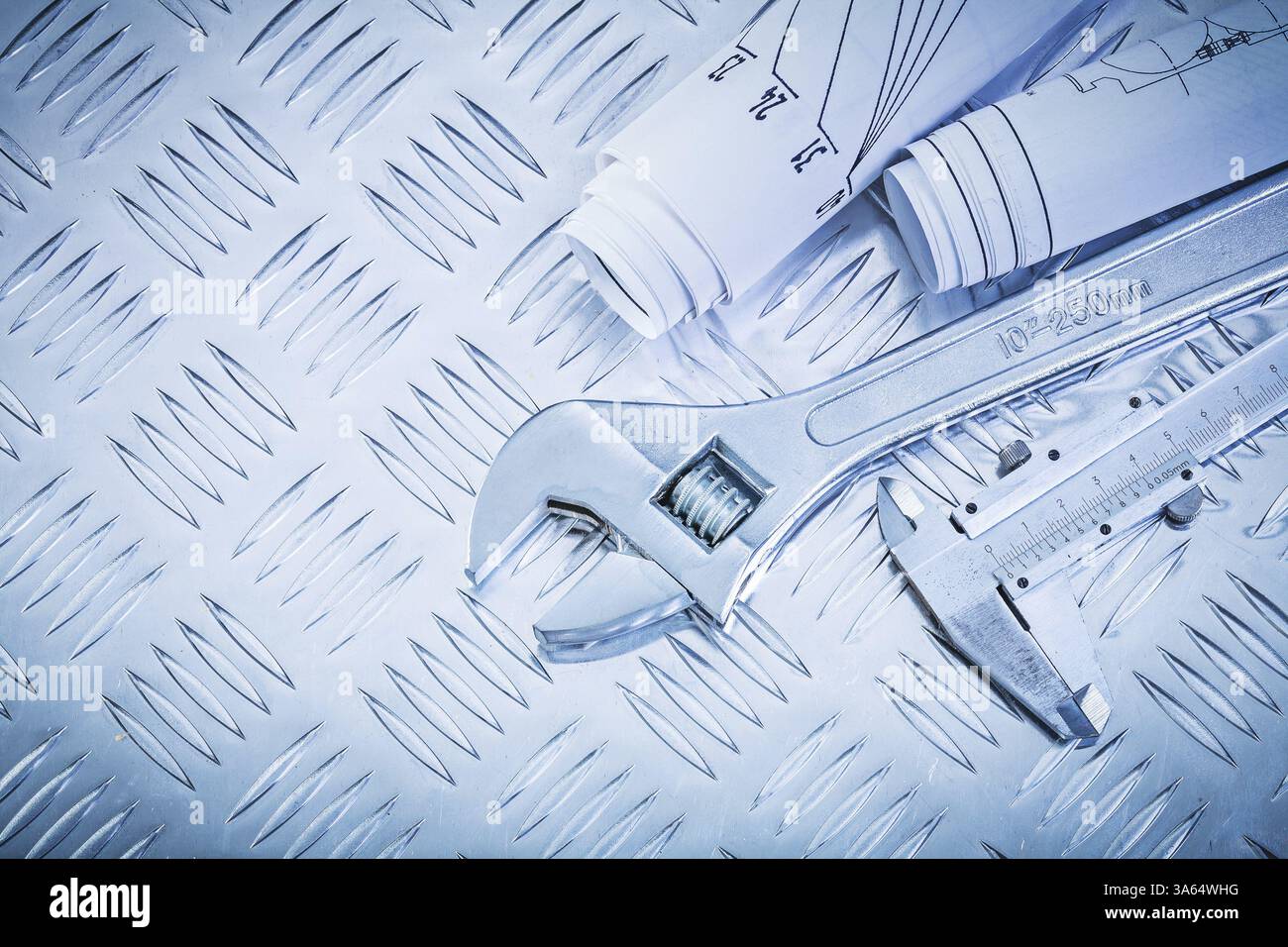 Blueprints vernier caliper adjustable wrench on channeled metal sheet ...