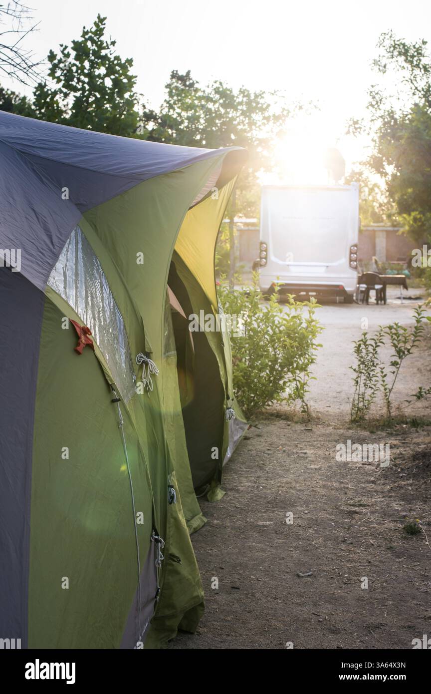 Camper in campsite at the morning sunrise Stock Photo - Alamy