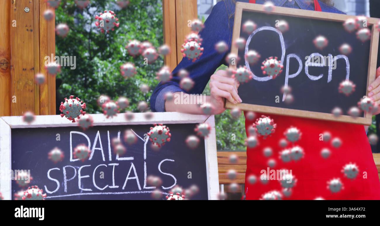 Restaurant worker holding Open sign with floating virus particles in ...