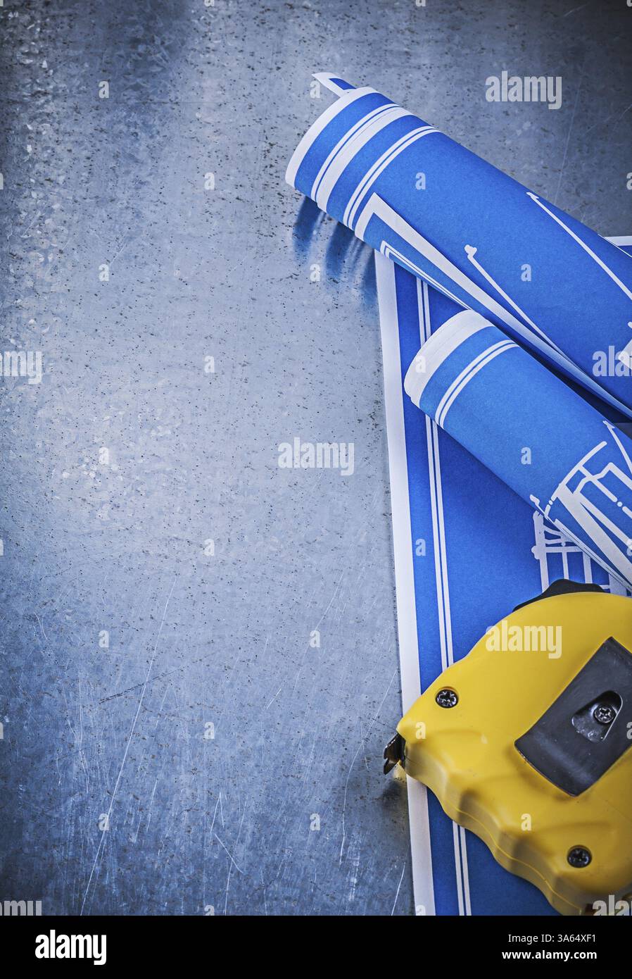 Composition of blue construction plans measuring line on metallic ...