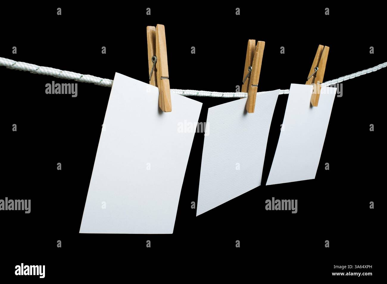 Note papers hooked on a rope. Balck isolated studio shot Stock Photo ...