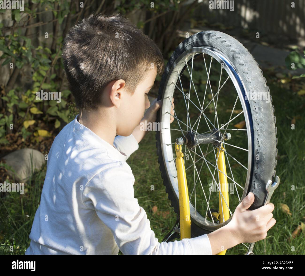 Child who fix bikes. Boy and bicycle Stock Photo - Alamy