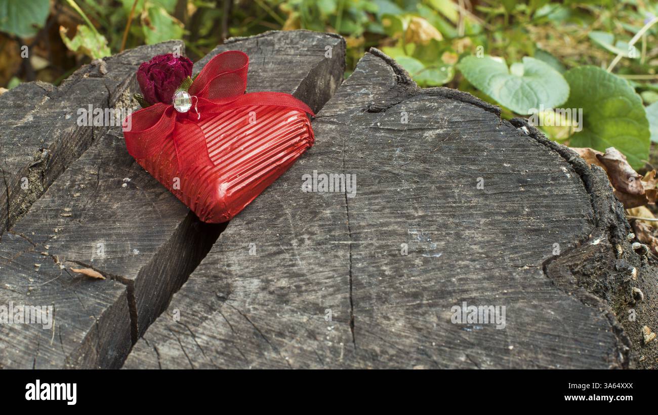 Red wrapped heart on wooden background Stock Photo - Alamy