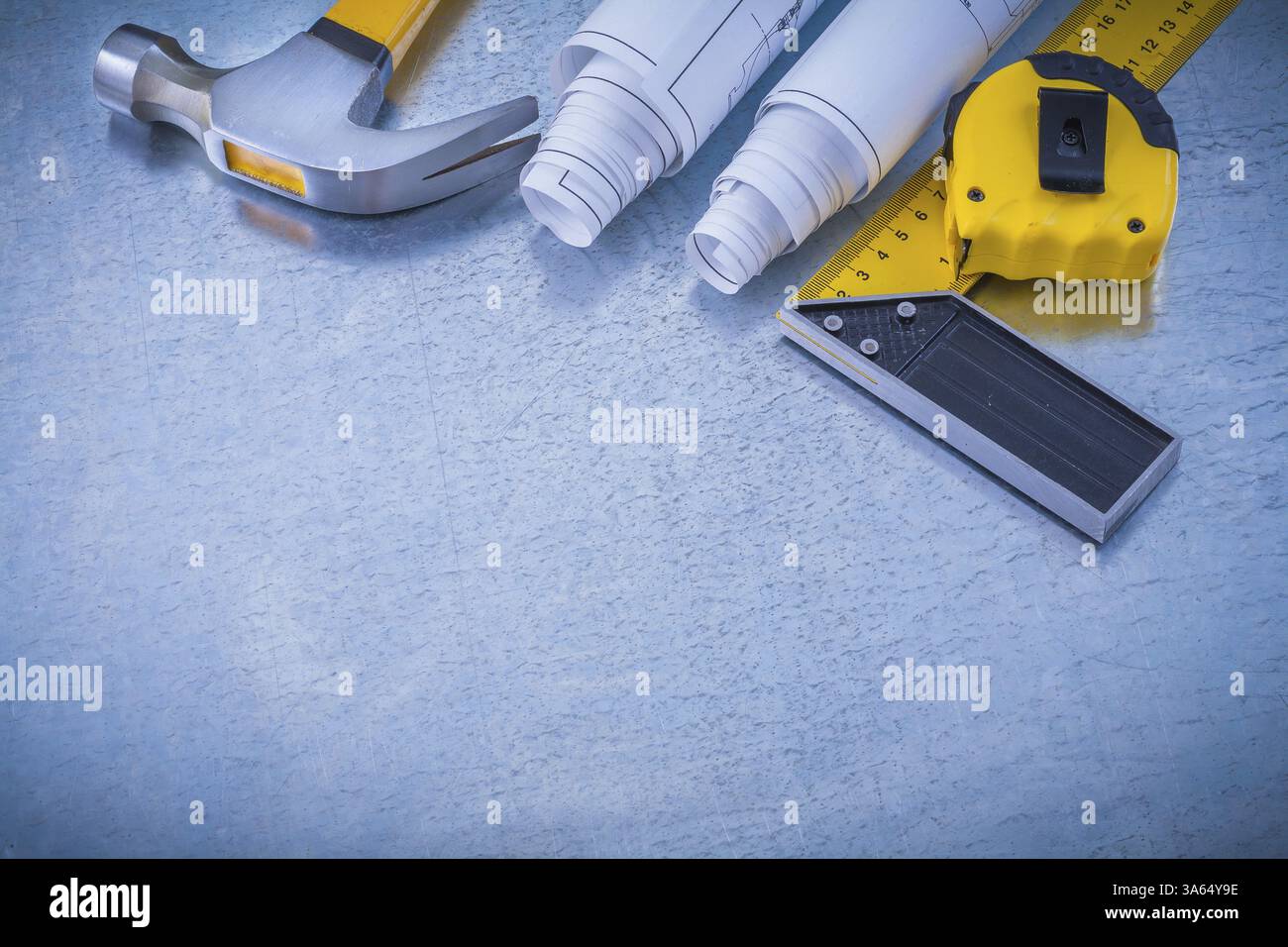 Construction plans measuring line square ruler and claw hammer on ...
