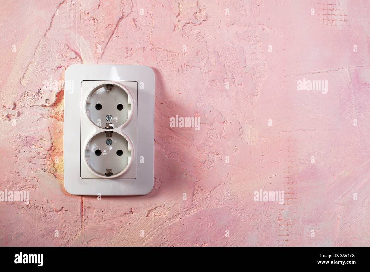 White socket on pink wall. Double socket Stock Photo - Alamy