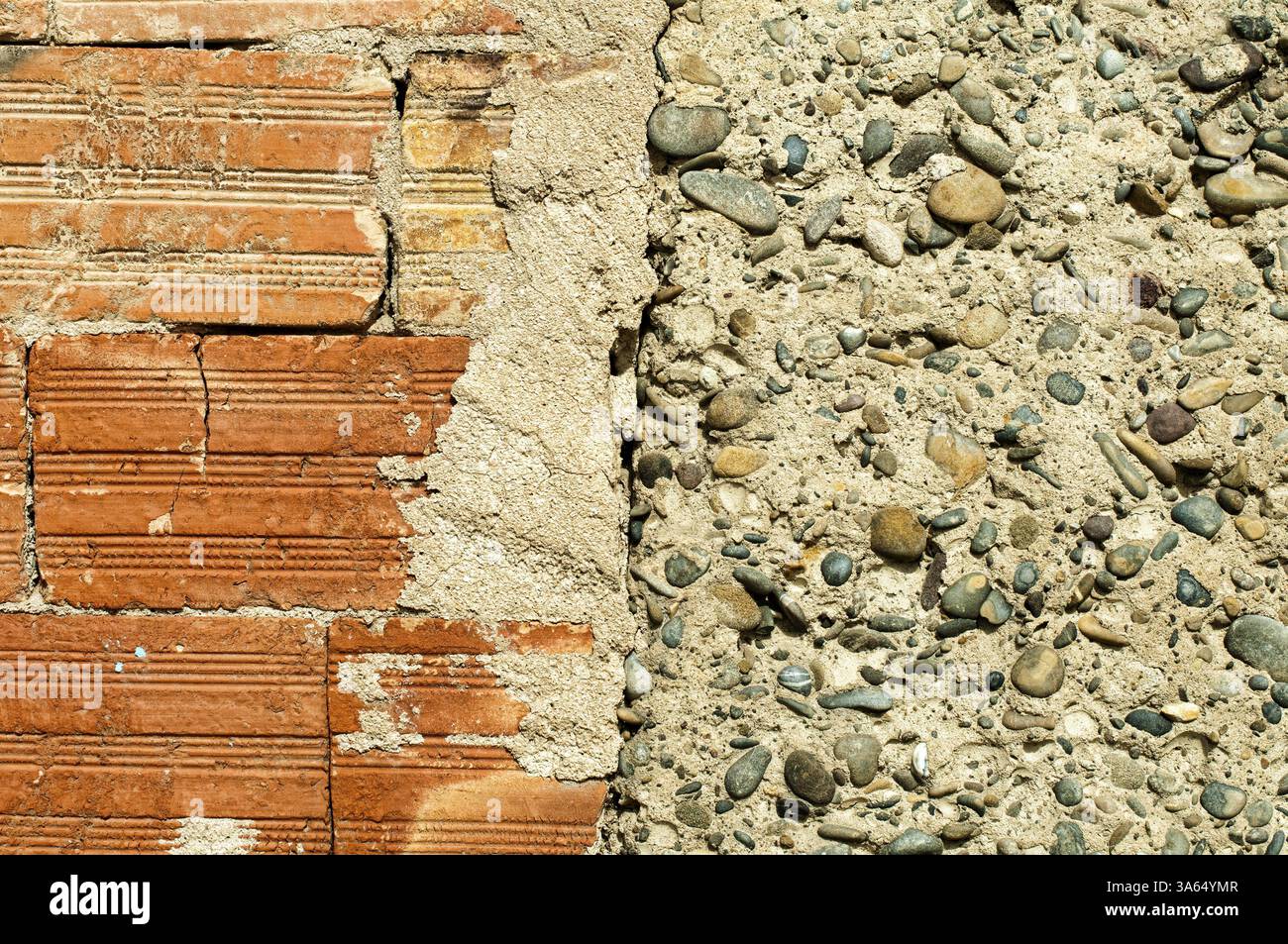 Wall of bricks and stones. Half bricks half beton Stock Photo - Alamy