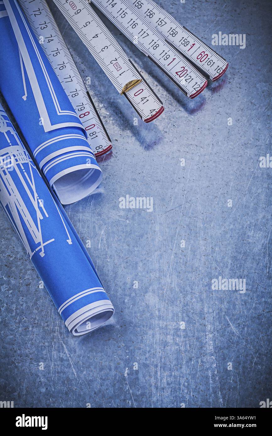 Blue engineering drawings wooden meter on metallic background ...