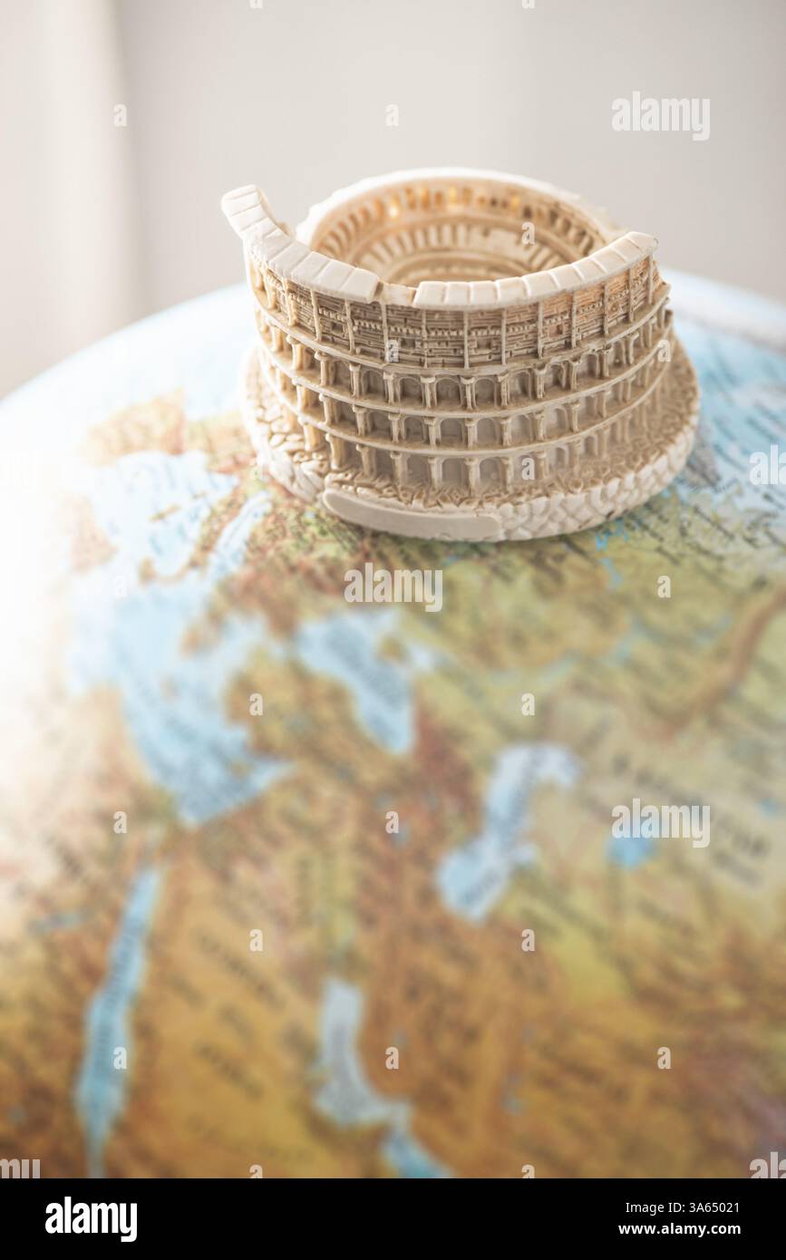 Coliseum of Rome on globe. Miniature concept Stock Photo - Alamy