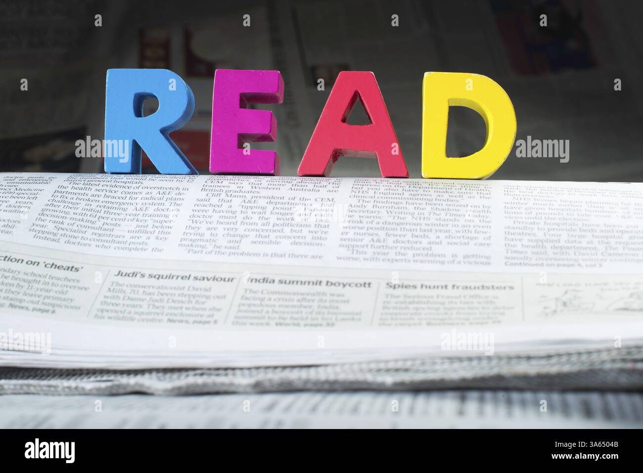 Word read on newspaper. Wooden letters Stock Photo - Alamy