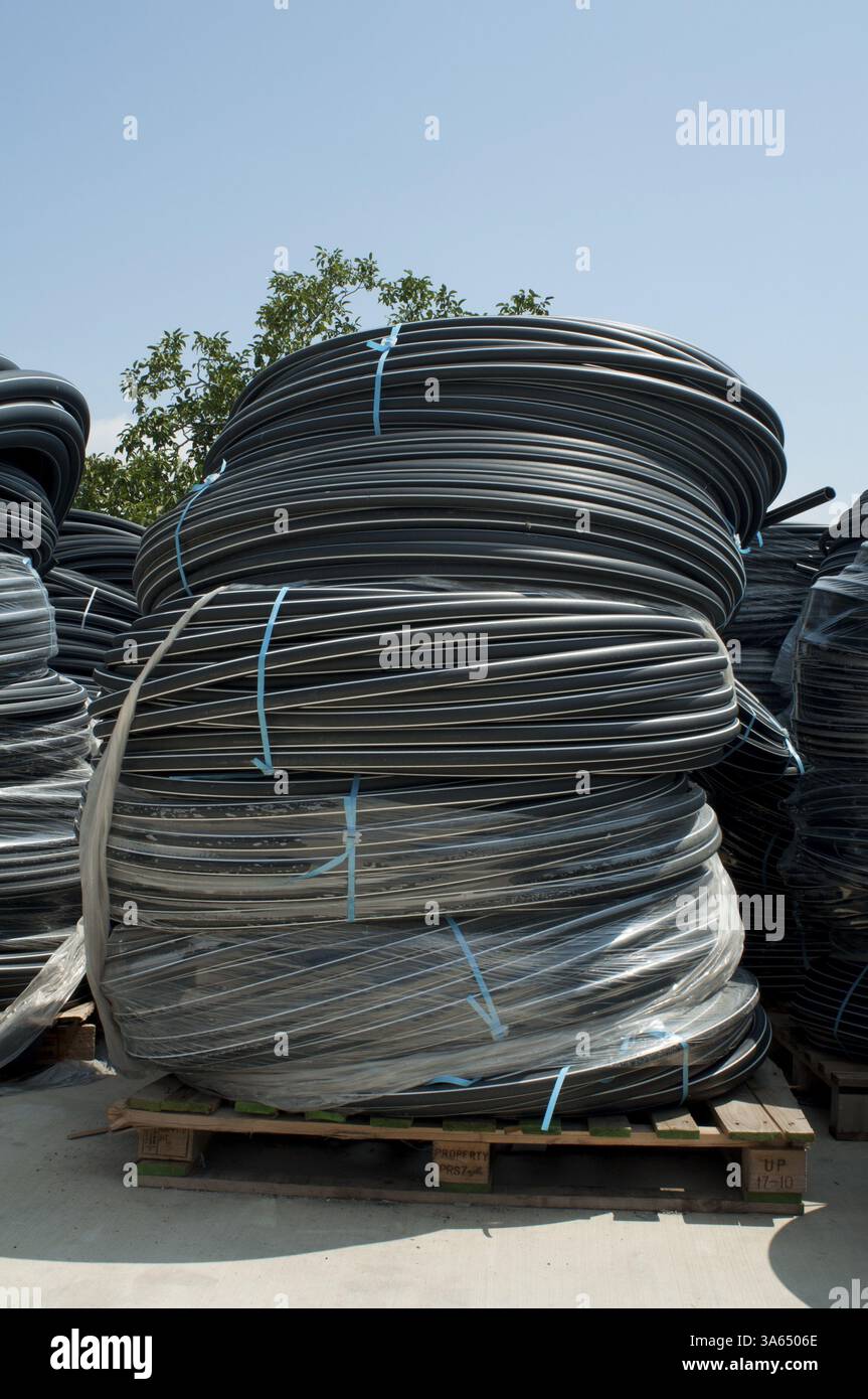Coiled black PVC hoses. Polyethylene tubing Stock Photo - Alamy