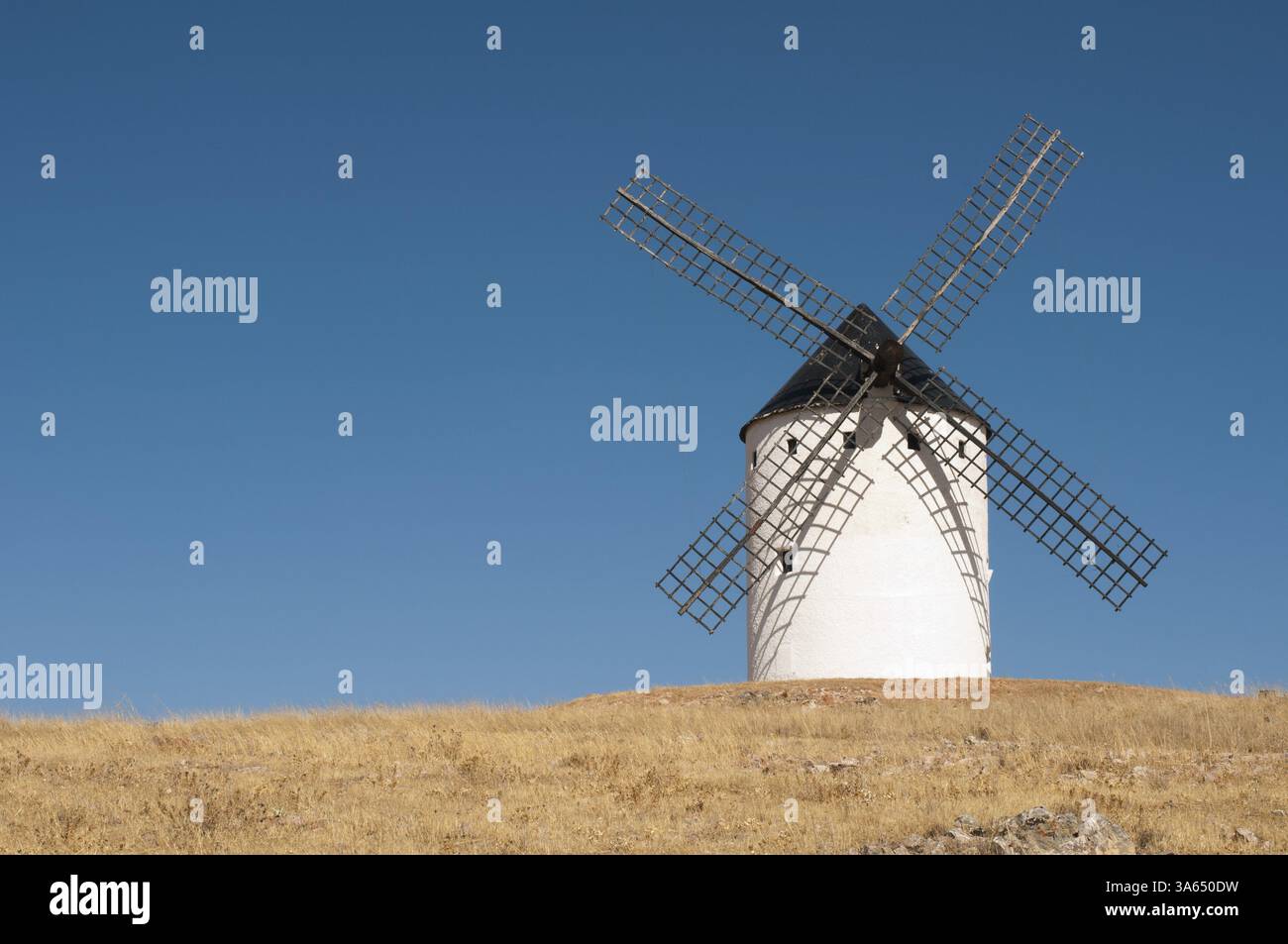 White ancient windmill. Blue sky background Stock Photo - Alamy
