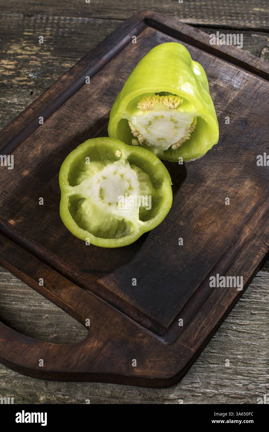 Cut green pepper on wood. Backlight Stock Photo - Alamy