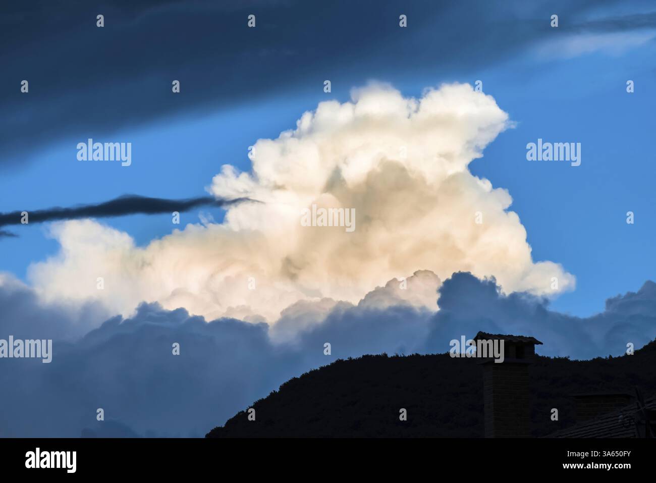 Dramatic clouds and deep blue sky. Sunset Stock Photo - Alamy
