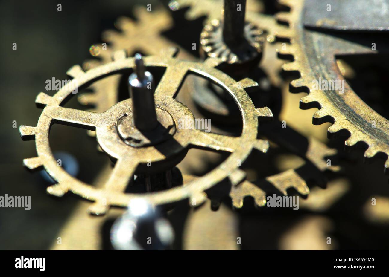 Close up metal gears mechanism. Golden colours. Hard light. Clock ...