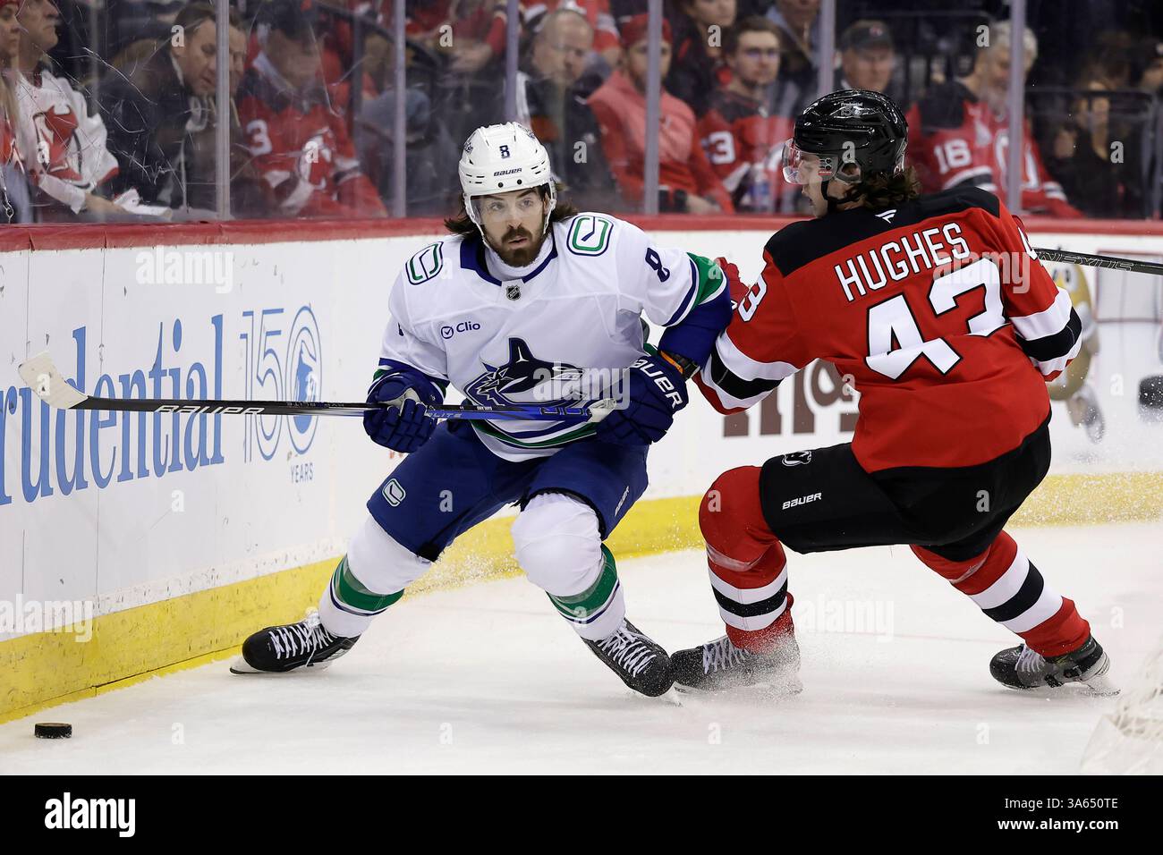 Vancouver Canucks right wing Conor Garland (8) battles for the puck ...