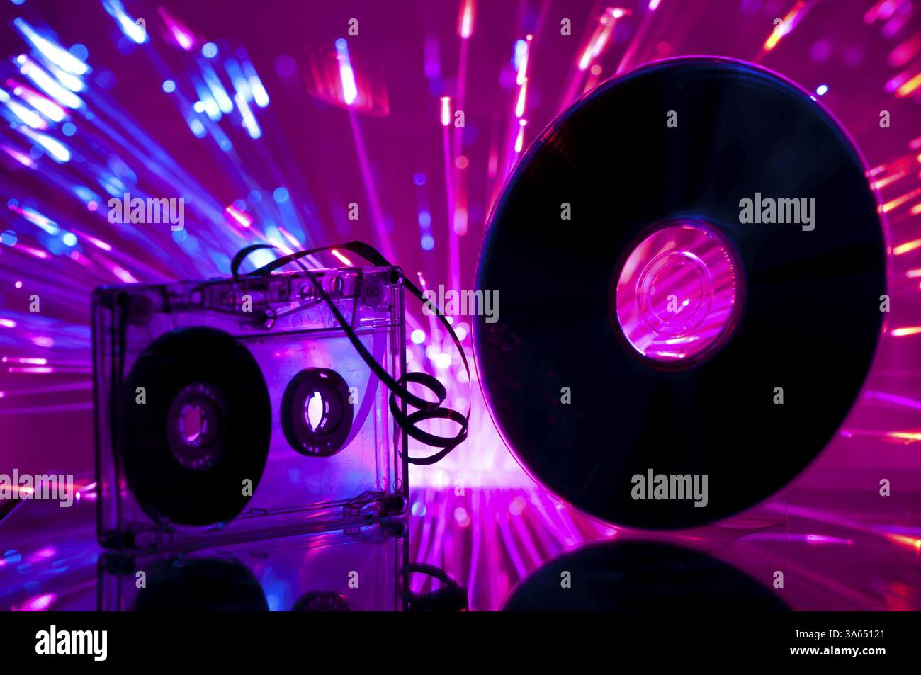 Cassette tape and CD. Multicolored blue lights on background Stock ...