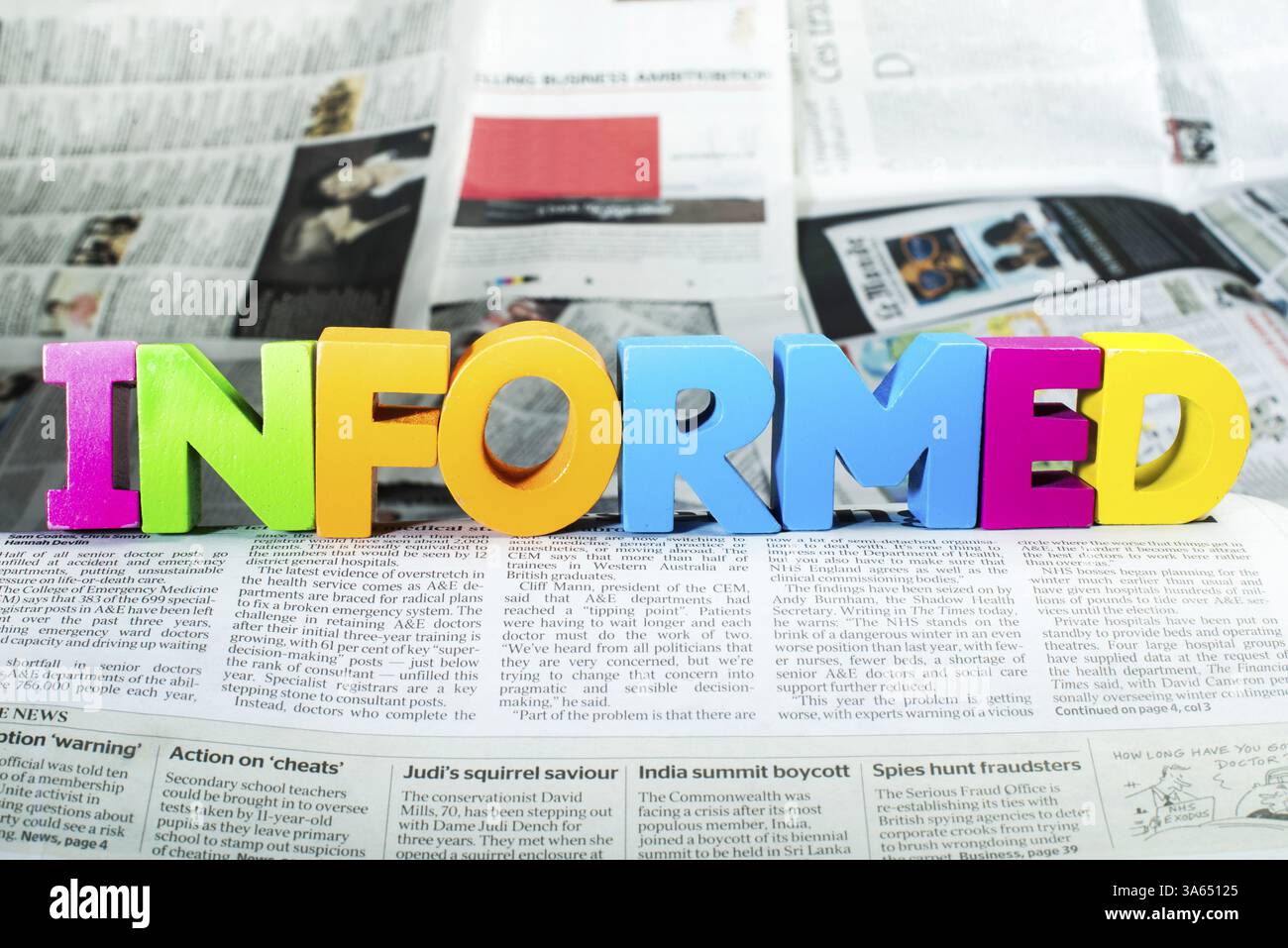 Word informed on newspaper. Wooden letters Stock Photo - Alamy