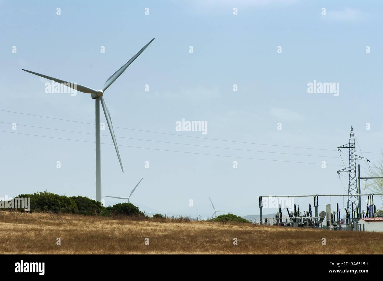 Wind generator and electrical substation. Blue sky Stock Photo - Alamy