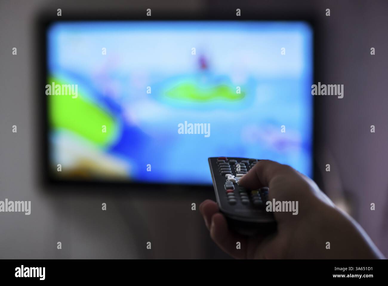 TV and remote control. Hand hold remote Stock Photo - Alamy