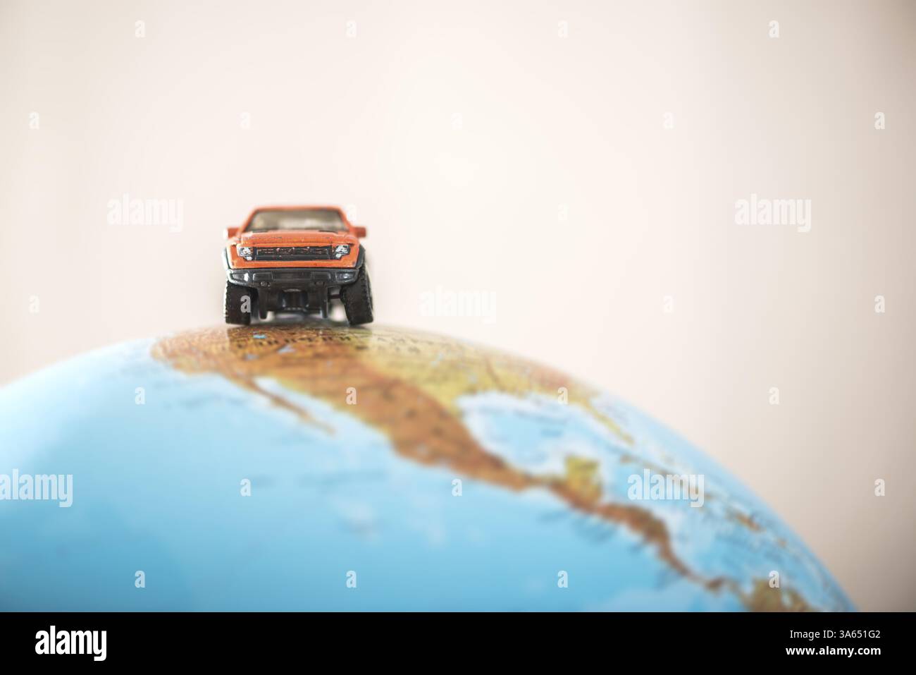 Offroad car on globe. Miniature concept Stock Photo - Alamy