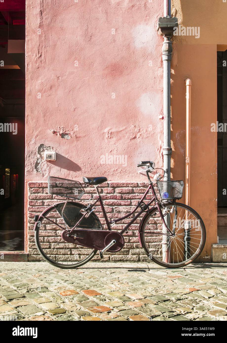 Red old Italian bicycle on sunlight. Ancient buildings Stock Photo - Alamy