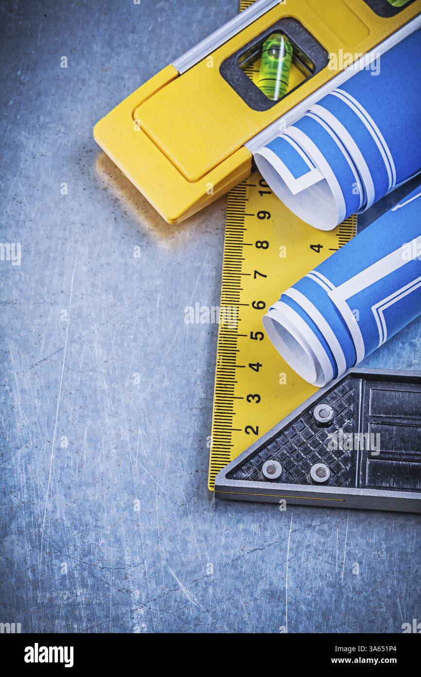 Blue blueprints construction level try square on metallic background ...