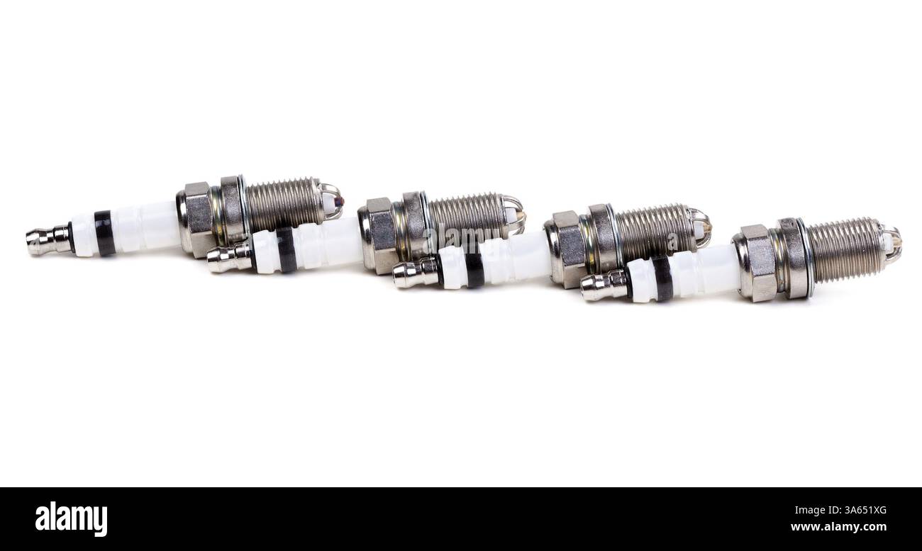 Set of four spark plugs the car on a white background Stock Photo - Alamy
