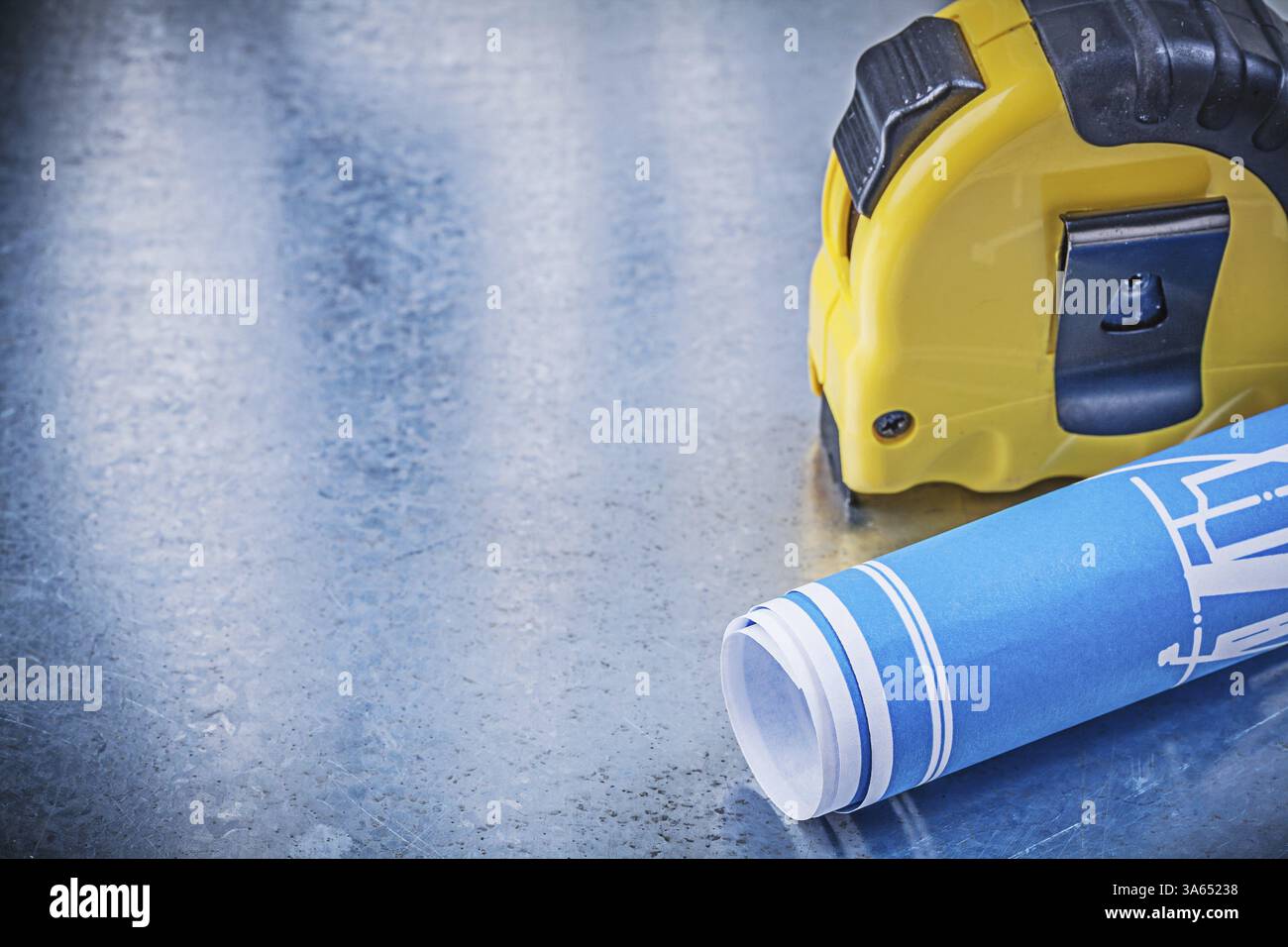 Blue engineering drawings tape measure on metallic background ...
