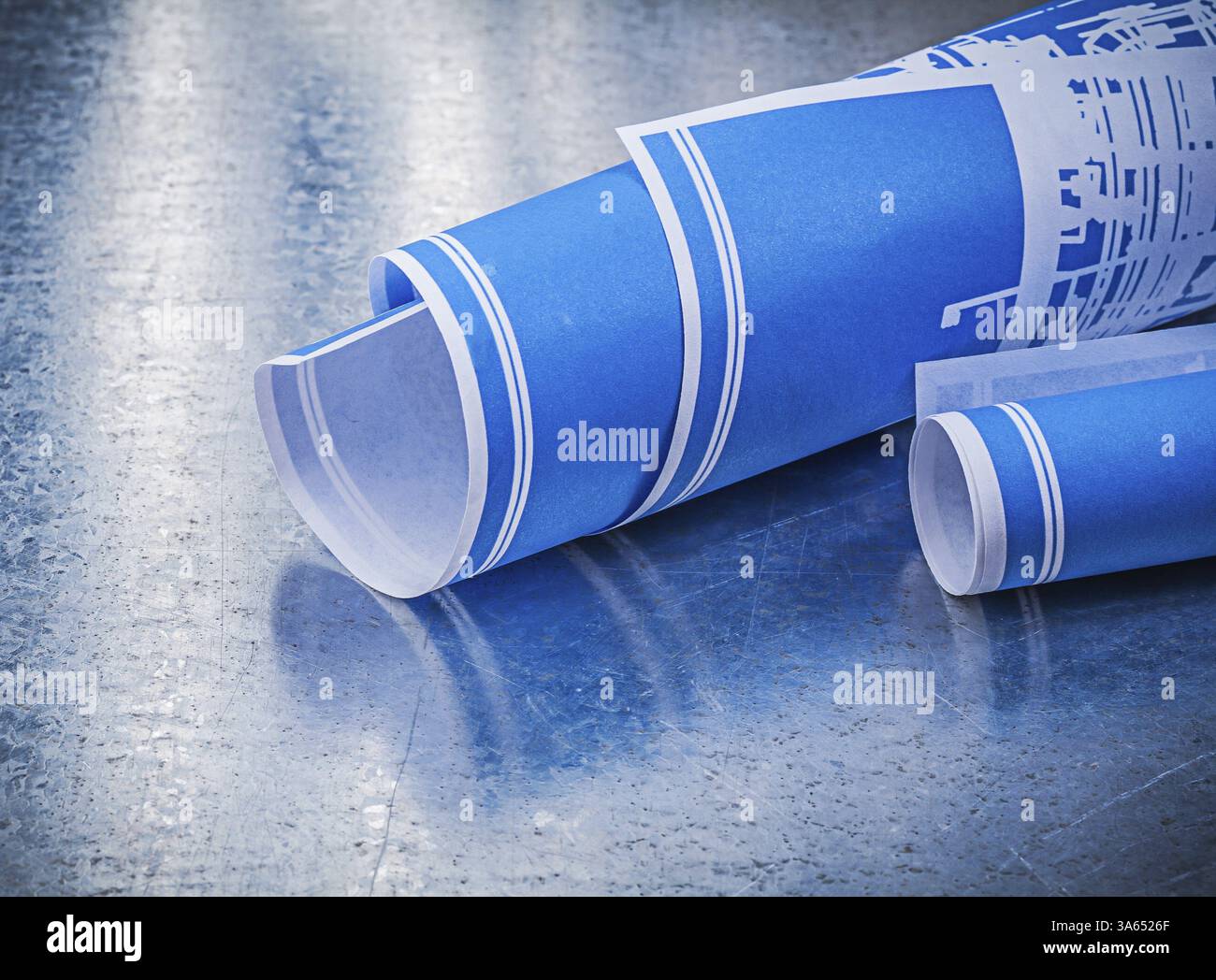 Blue engineering drawings on metallic background construction concept ...