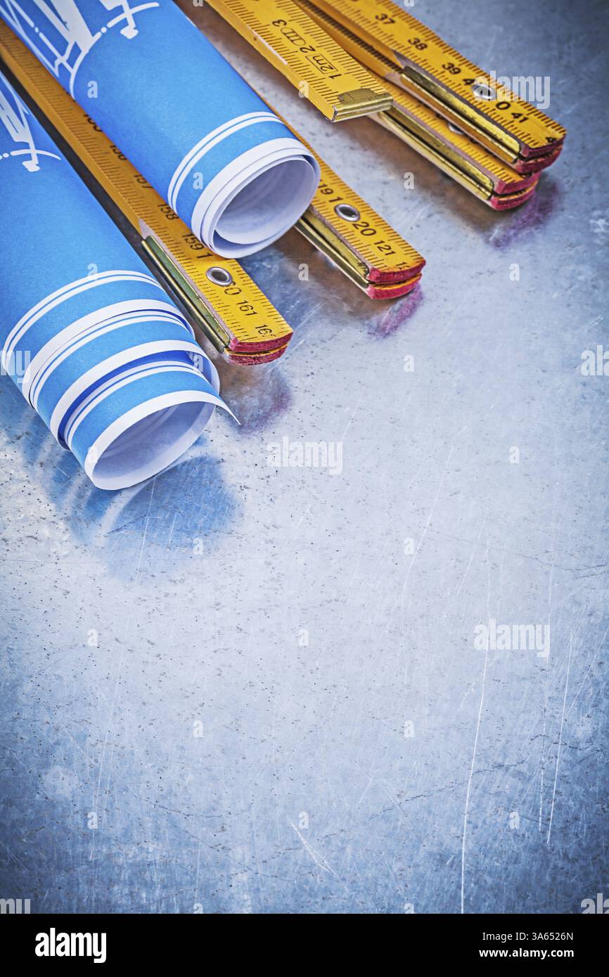 Composition of blue blueprints wooden meter on metallic background ...