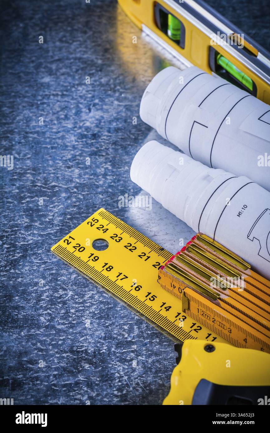 Construction level blueprints and instruments of measurement on ...