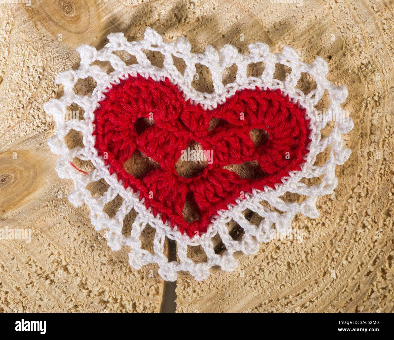 Heart shape made of red textile on wooden base Stock Photo - Alamy