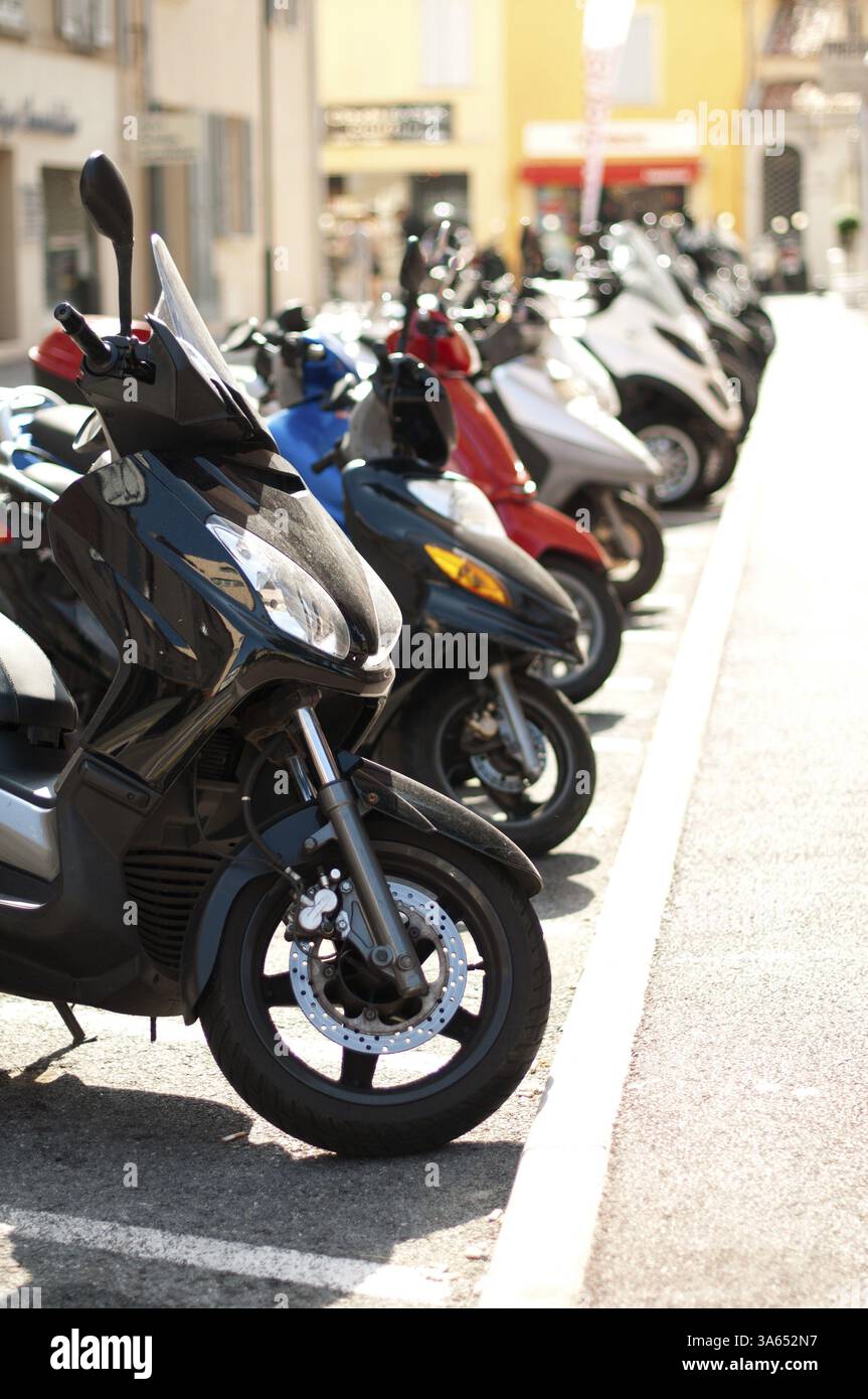 A line of mopeds/scooters on the city street Stock Photo - Alamy
