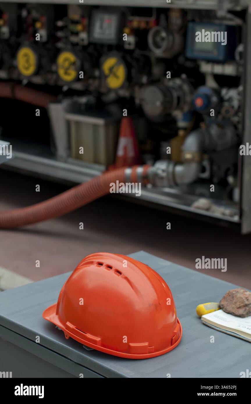 Fuel truck and red helmet close up Stock Photo - Alamy