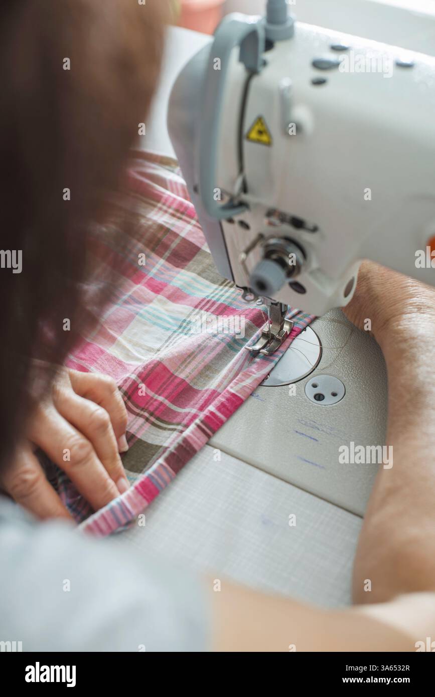 Women sew on sewing machine. White machine Stock Photo - Alamy
