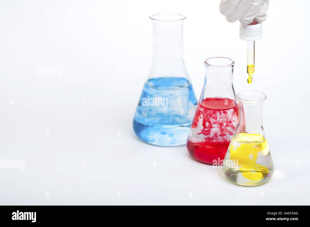 Laboratory equipment and color chemicals on white background Stock ...