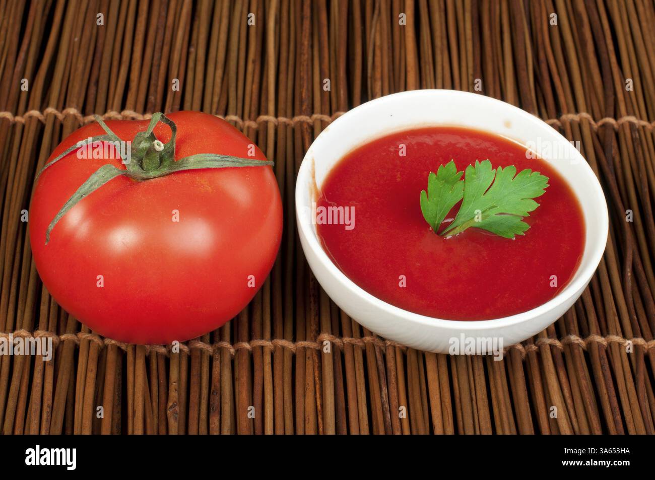 Tomato and Bowl of tomato sauce on wooden base Stock Photo - Alamy