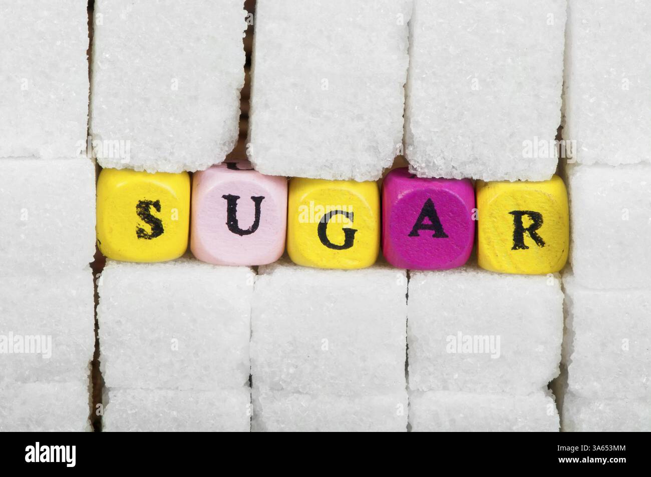 Sugar lumps and word sugar. Multicolored cubes Stock Photo - Alamy