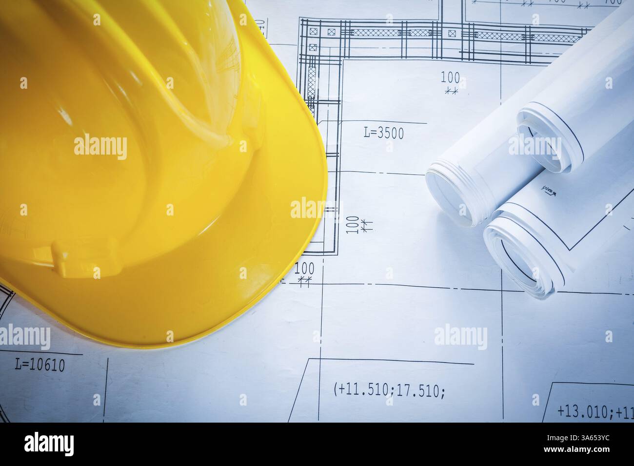 Protective building helmet construction plans on blueprint Stock Photo ...