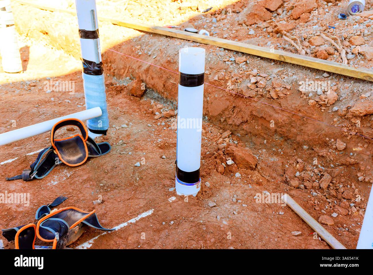 Prepare construction site with drainage PVC pipes fitting connections in trench ready for ...