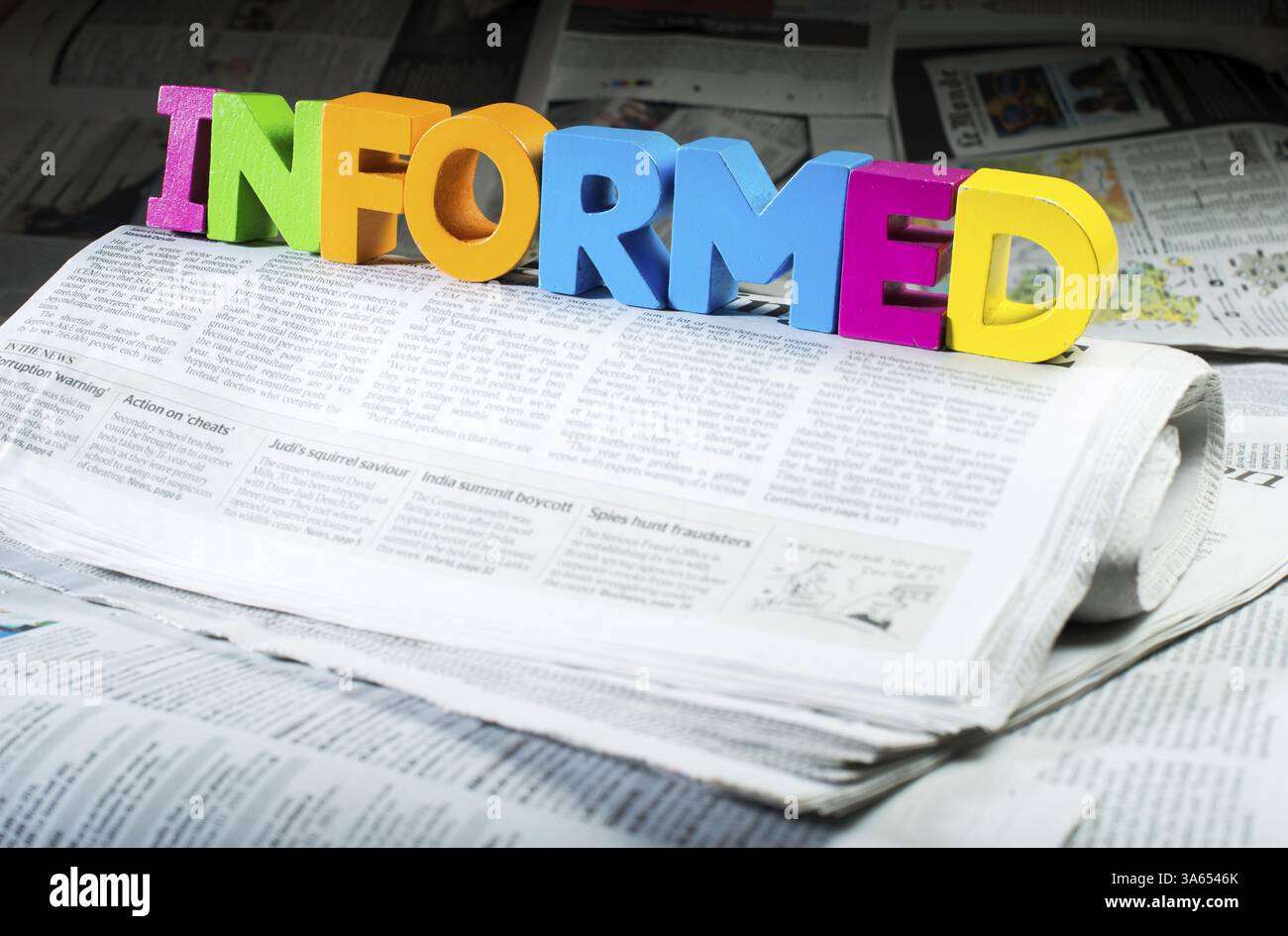 Word informed on newspaper. Wooden letters Stock Photo - Alamy