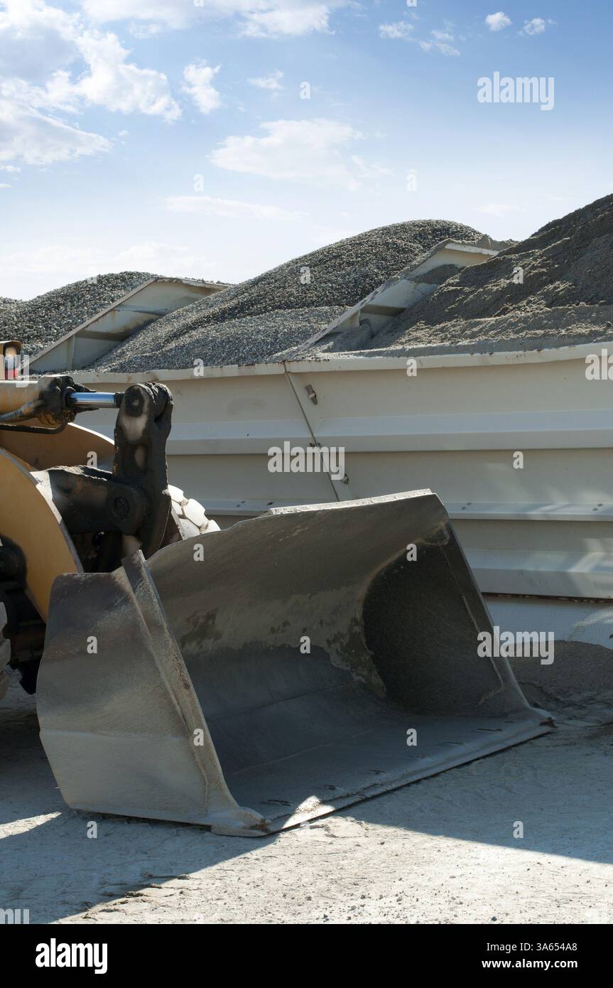 Excavator close-up and piles of sand background. Vertical image Stock ...